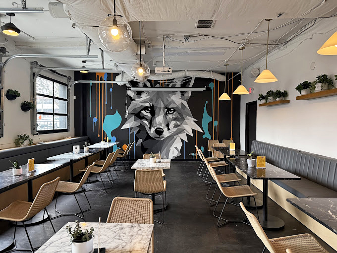 The fox watches over all in this artfully designed dining space where comfort meets cool in perfect harmony.
