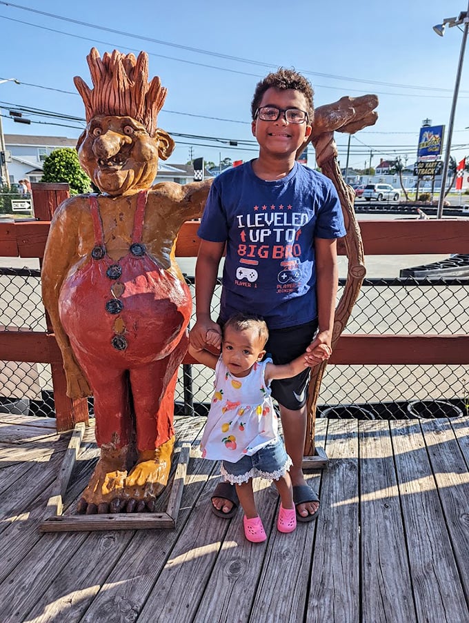 Creating memories that last longer than sunburns, these young visitors discover the joy of posing with Viking-themed sculptures.