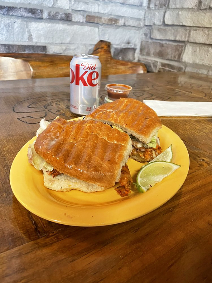 This torta isn't just a sandwich—it's an engineering marvel of crispy bread, savory filling, and the essential fresh lime to tie it all together.