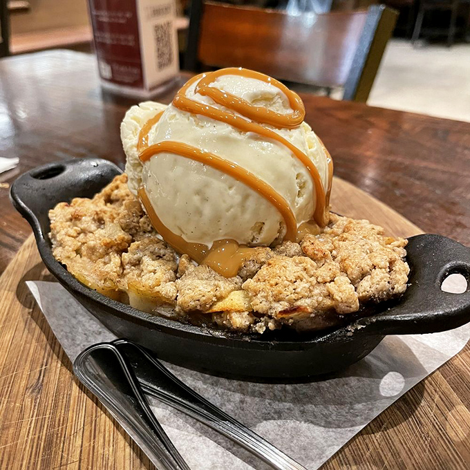 The apple crumble arrives sizzling in its own cast-iron skillet&mdash;ice cream melting into warm, buttery crumble like a delicious meteor hitting a tasty planet.