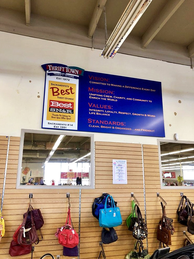 The handbag wall&mdash;where designer dreams meet thrift store prices. That blue tote might have once carried important documents to important meetings.