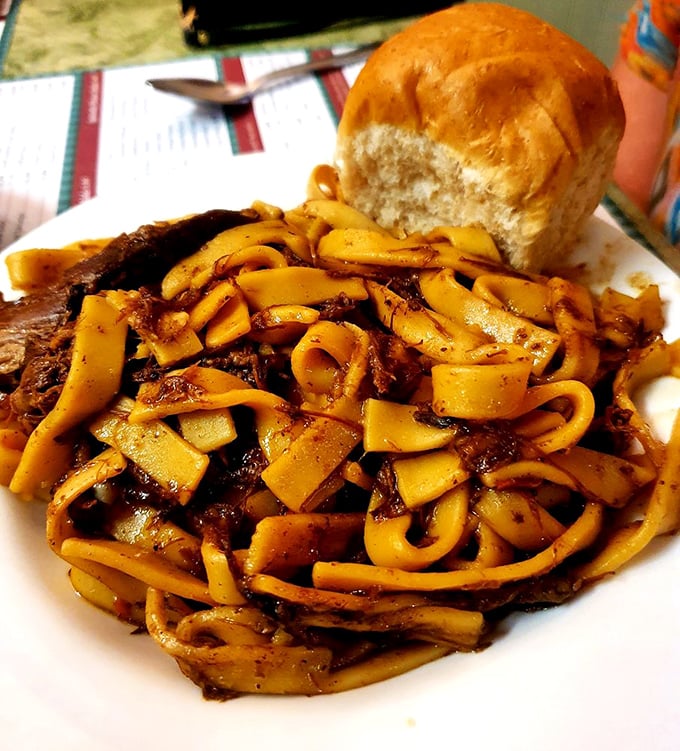 Beef and noodles with a dinner roll standing by for gravy-sopping duty. Comfort food that makes your grandmother's version seem like amateur hour.