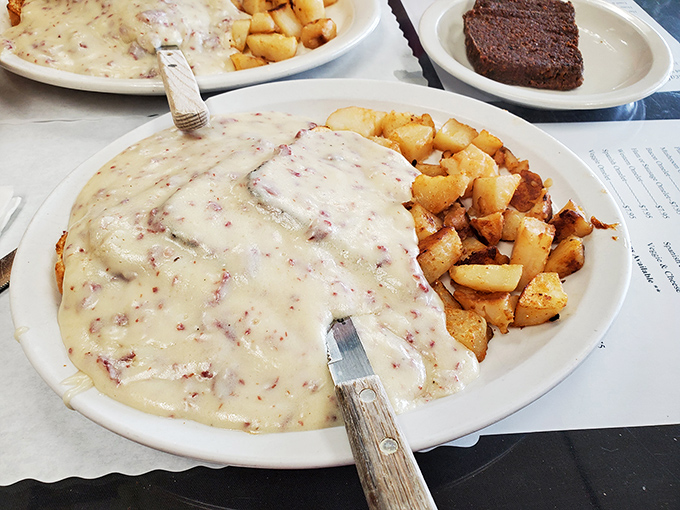 Biscuits swimming in creamy sausage gravy&mdash;the kind of dish that makes you want to hug the cook and take a nap simultaneously.