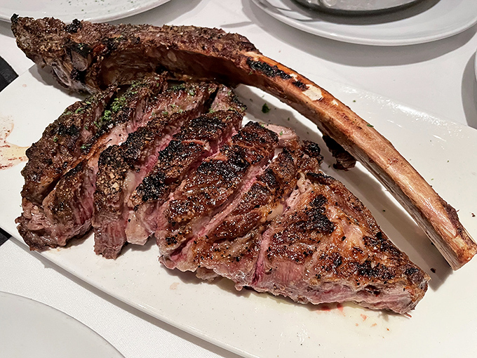 The tomahawk steak &ndash; part dinner, part spectacle. This bone-in beauty has been perfectly sliced to reveal a medium-rare interior that's practically blushing.