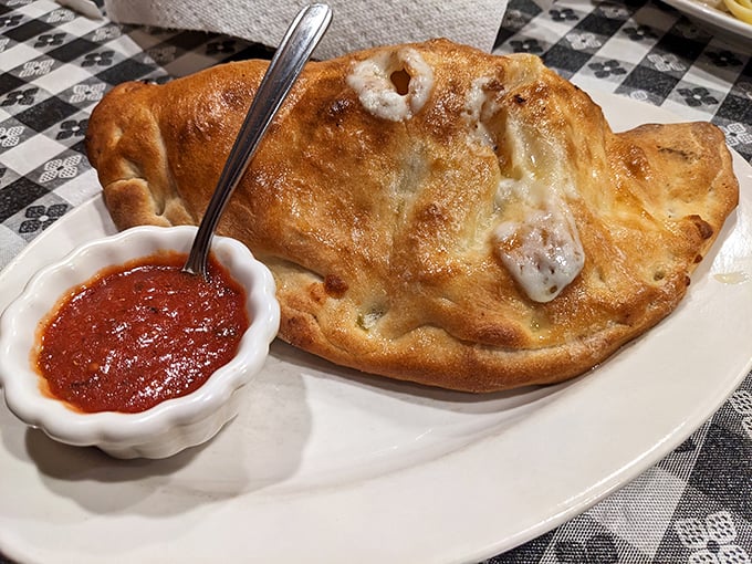 This calzone isn't just food&mdash;it's architecture. A golden-domed cathedral of cheese with marinara holy water on the side.