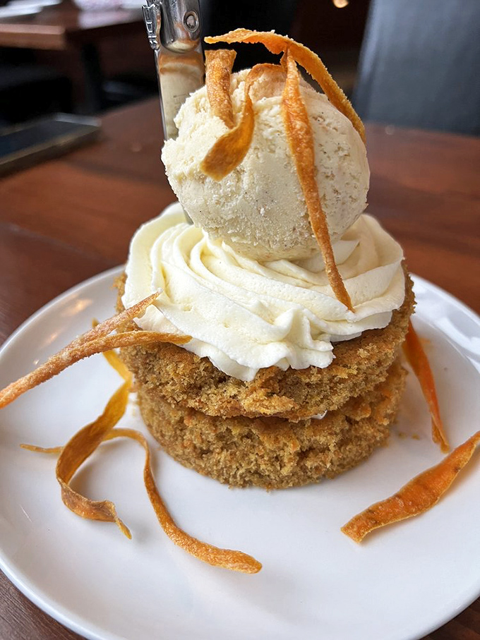 Carrot cake reimagined as architectural wonder. Those crispy carrot ribbons are what happen when vegetables decide to dress for a gala.