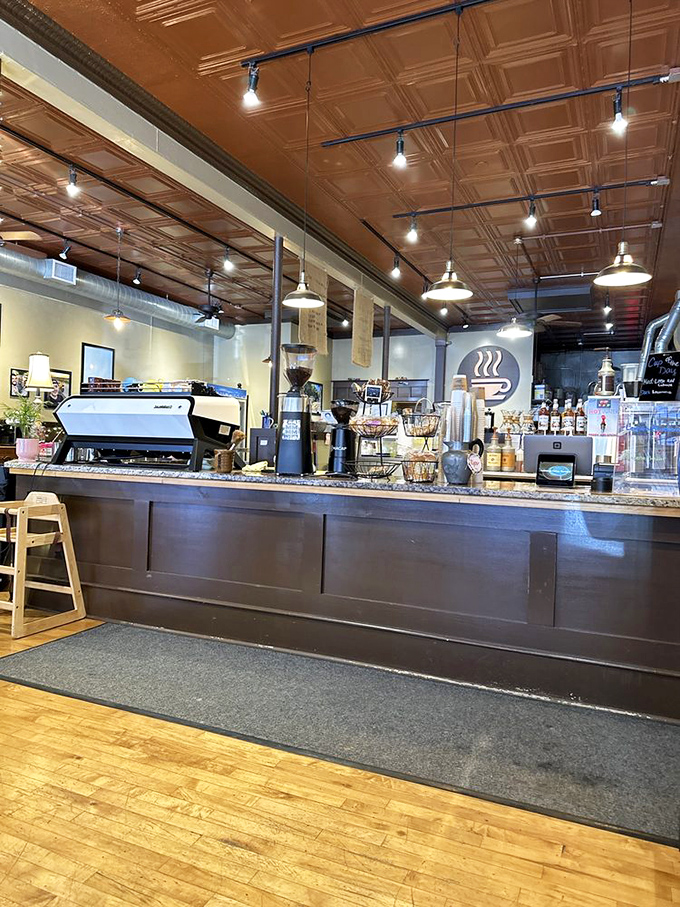The copper espresso machine gleams like a steampunk fantasy, while the pressed tin ceiling adds vintage charm to this coffee sanctuary.