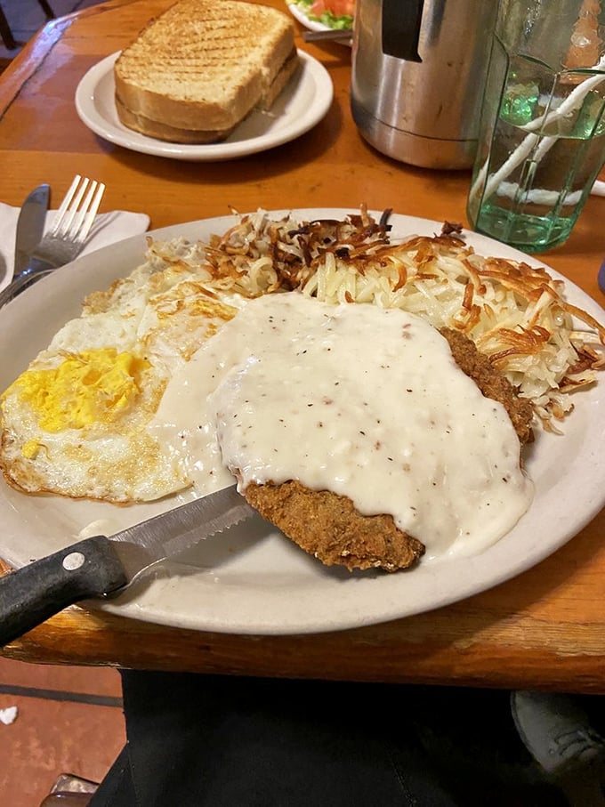 Country-fried steak smothered in gravy with crispy hash browns &ndash; breakfast of champions or delicious heart attack? Both!