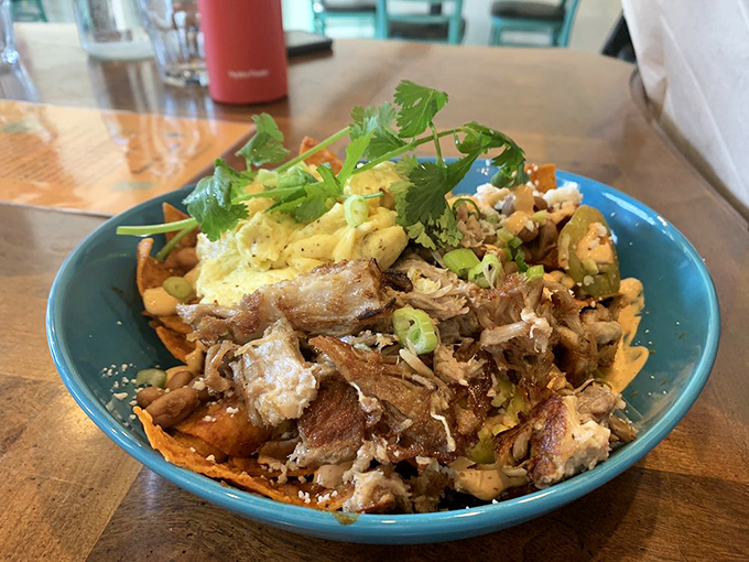 The vibrant green counter area doubles as a stage where breakfast dreams come true, complete with pastry display that tests your willpower.