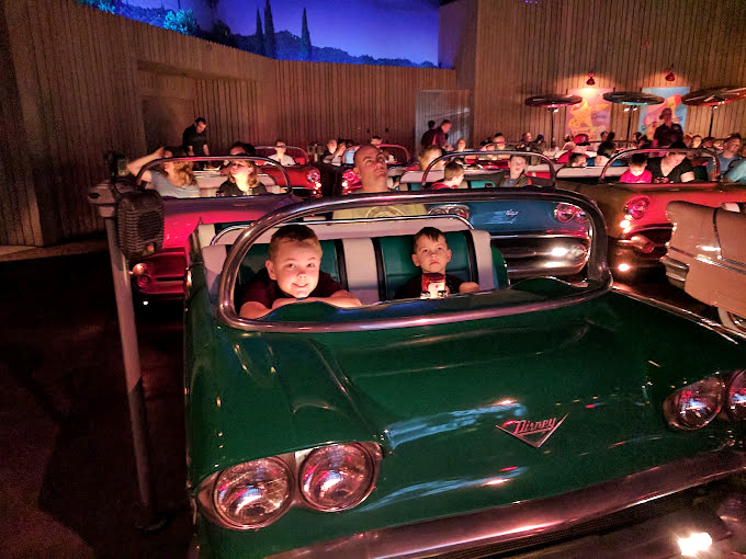 The kids' faces say it all: "We're eating dinner in a CAR while watching CARTOONS. Best. Day. Ever."