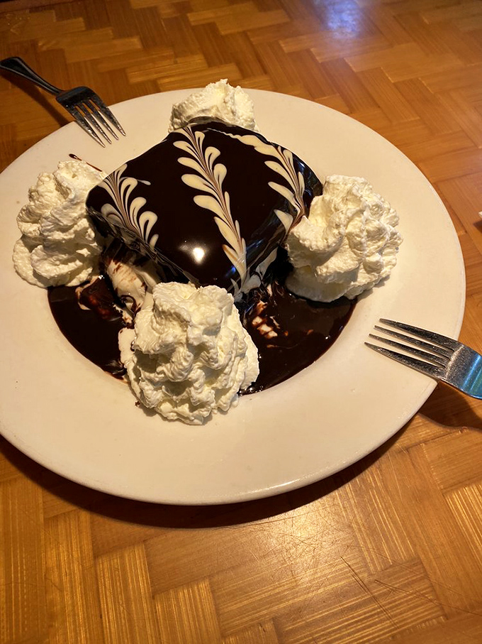 A chocolate dessert so decadent it should come with its own warning label. Those whipped cream peaks are practically showing off.