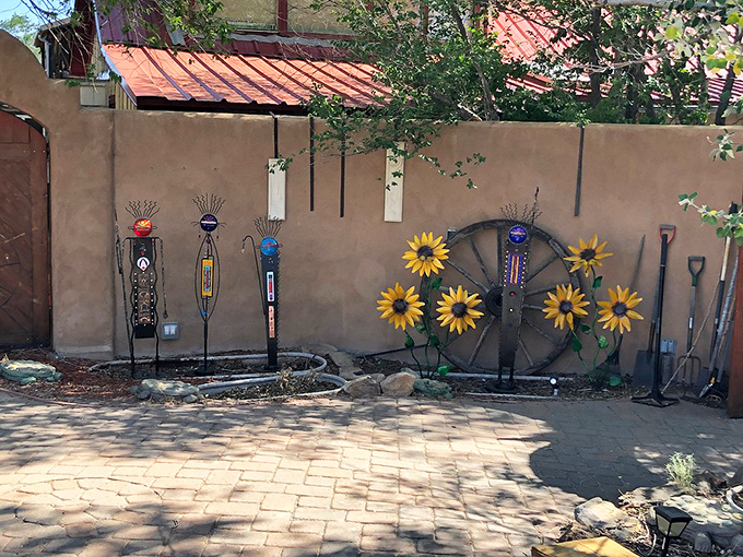 Garden art with southwestern flair&mdash;old tools transformed into sunflowers and figures, proving Madrid's creative spirit extends beyond gallery walls.