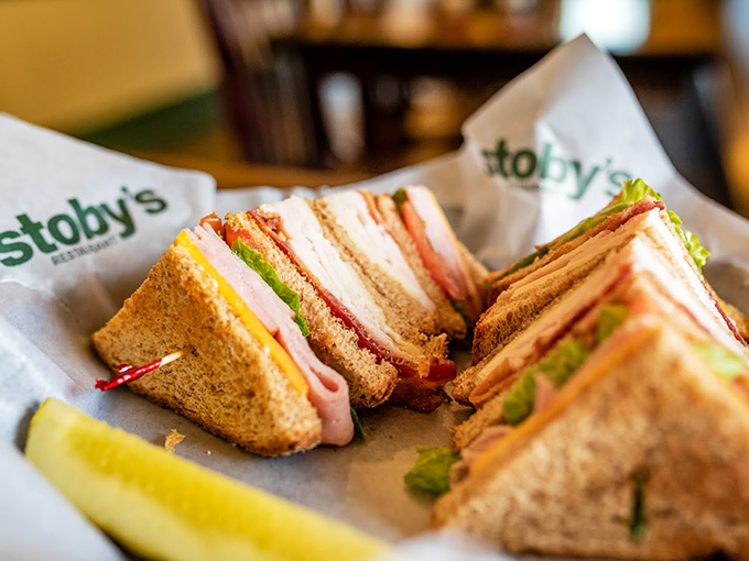 Club sandwiches stacked higher than my college debt, with layers that deserve their own geological survey.