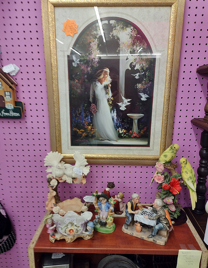 Religious imagery nestled among porcelain figurines tells stories of faith and decoration. Pink pegboard makes an unexpectedly perfect backdrop.