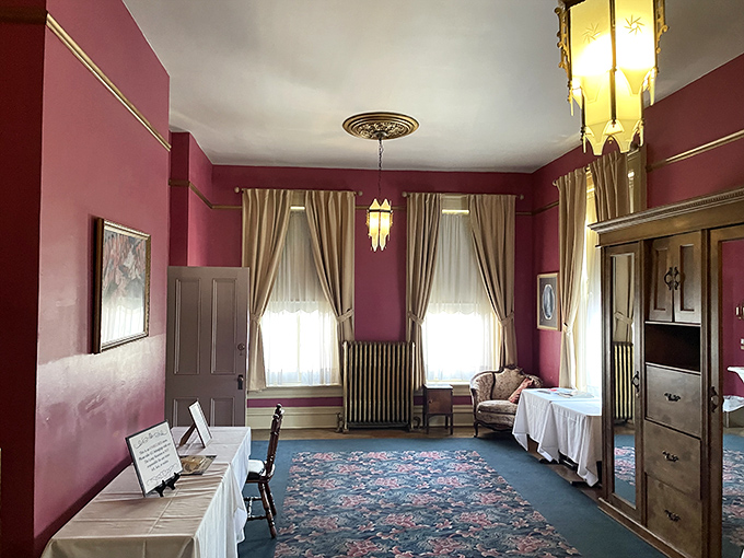 Rich burgundy walls and period furnishings recreate the mansion's heyday. This room feels frozen in time, as if the Lemps might return any moment.