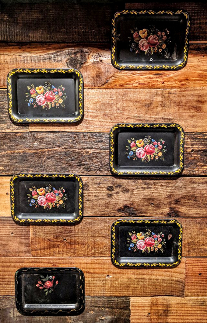 Vintage floral trays add unexpected charm to the rustic space. Like finding your grandmother's china in a woodworker's workshop. 