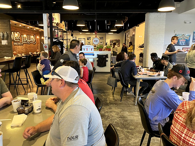 A packed house of diners all engaged in the serious business of enjoying food that makes conversation pause mid-sentence for another bite.