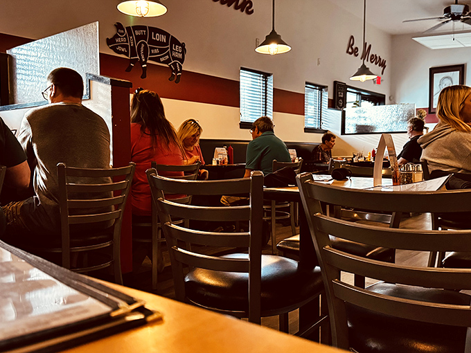 A dining room where strangers become friends over shared burger enthusiasm. The "Be Merry" sign isn't a suggestion—it's inevitable.