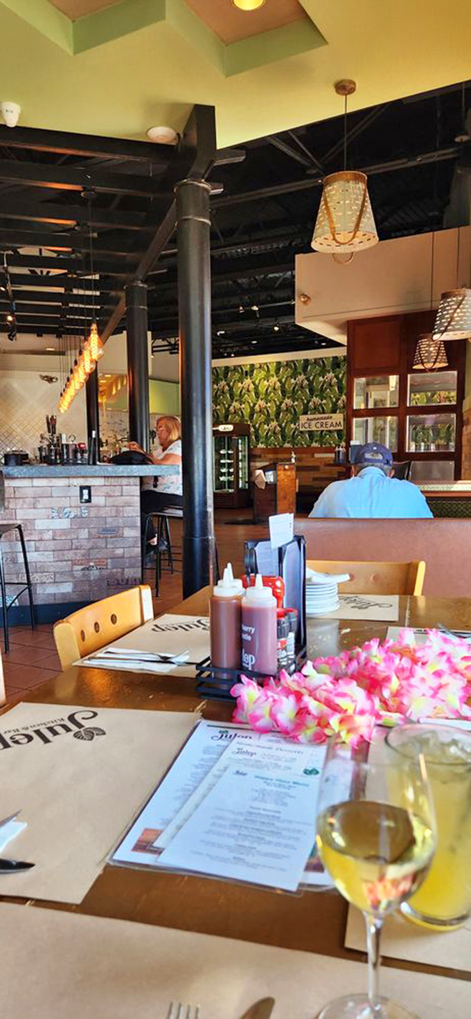The tropical flowers on the table say "vacation," while the condiment caddy says "we take our sauce selection as seriously as our smoked meats."
