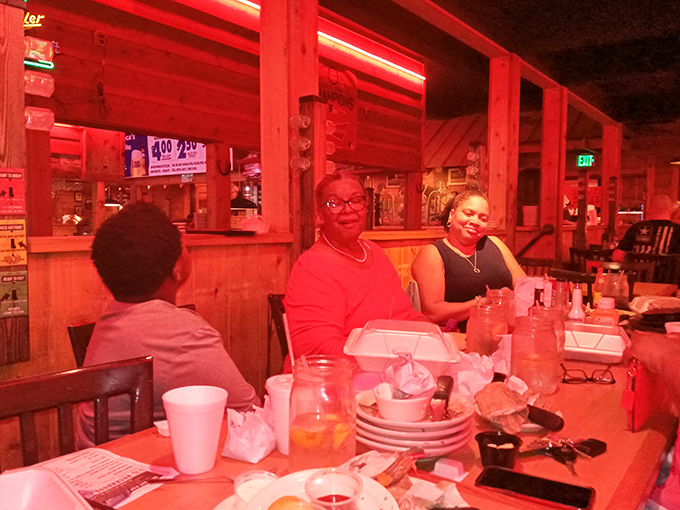 Red lighting bathes diners in a flattering glow that says, "Everyone looks good eating steak," while plates collect the evidence of appetites well-satisfied.