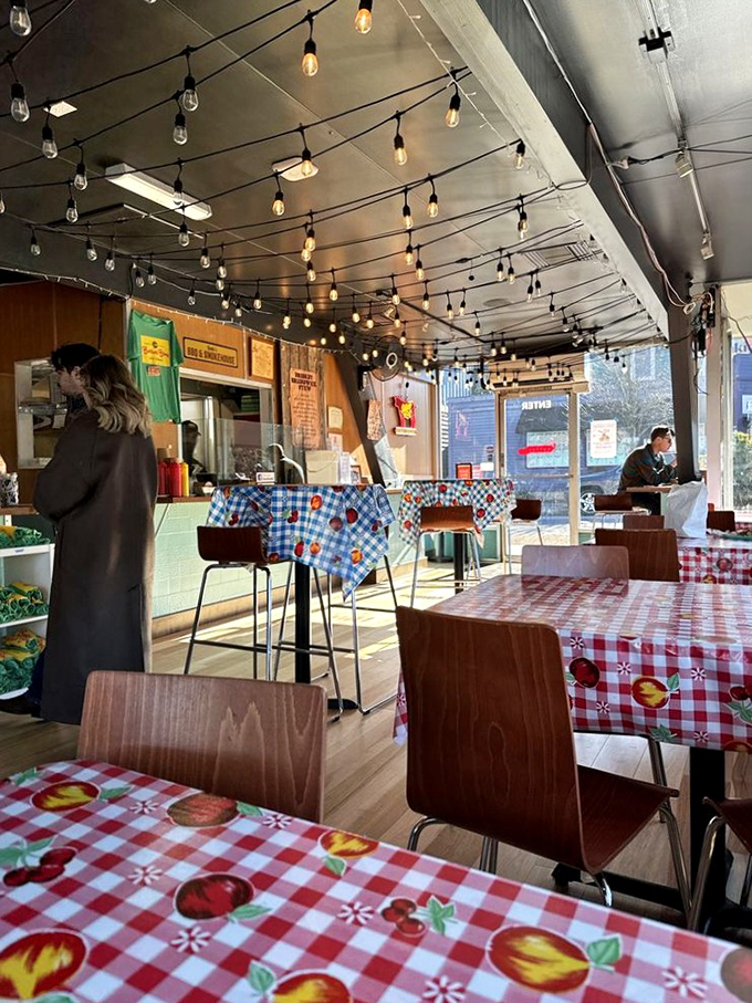 String lights create a warm glow over the dining area, where checkered tablecloths invite you to get messy with your meal. Barbecue is meant to be shared. 