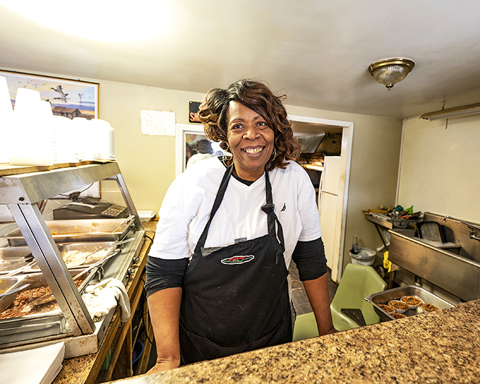 The smile behind the counter says it all&mdash;this isn't just cooking, it's sharing joy wrapped in corn husks.