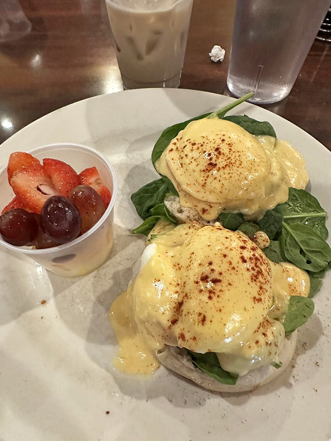 These eggs Benedict are dressed for success with their golden hollandaise coats, perched on spinach beds like royalty on throne cushions.