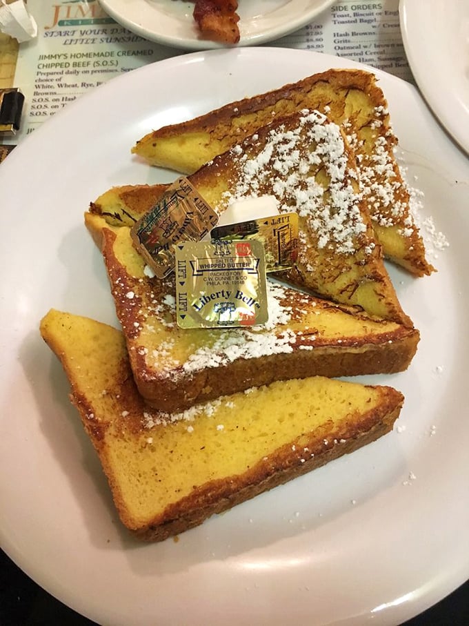 French toast that achieves that magical state between custardy center and caramelized exterior, dusted with powdered sugar for good measure.