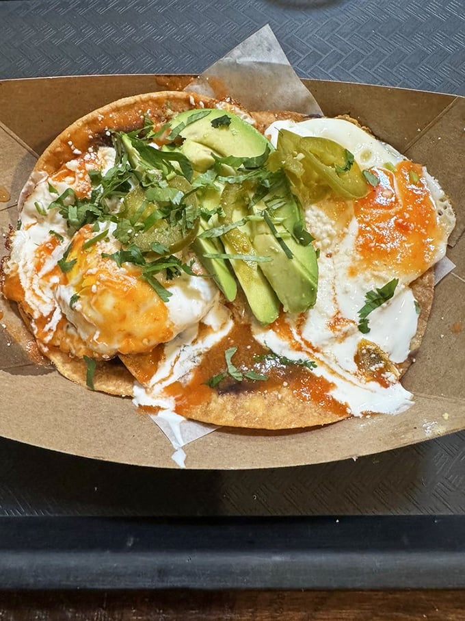 Breakfast meets lunch in this huevos rancheros masterpiece. The avocado slices are basically nature's butter, improving everything they touch.