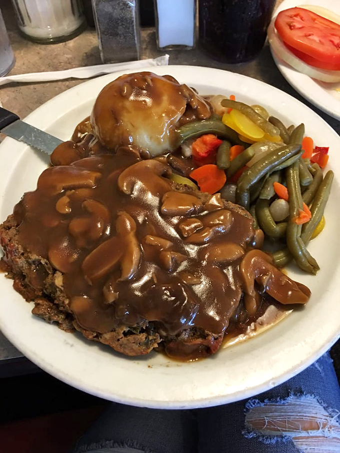 Comfort food that hugs your soul &ndash; this meatloaf smothered in rich gravy alongside colorful vegetables proves Rodie's mastery extends well beyond breakfast.