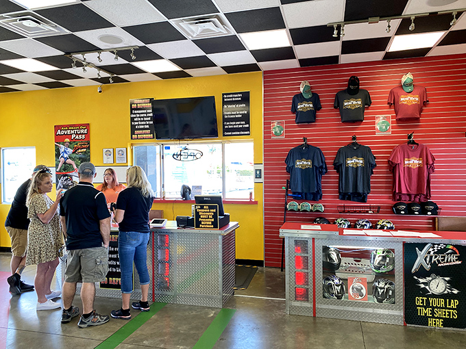 The well-appointed lobby balances racing memorabilia with practical check-in facilities. Those t-shirts are the socially acceptable way to brag about your lap times.