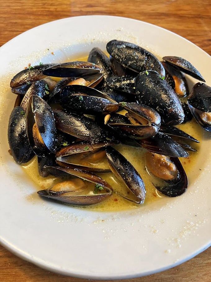 These mussels aren't just seafood; they're little black treasure chests, each one opening to reveal a perfect morsel swimming in buttery, garlicky bliss.