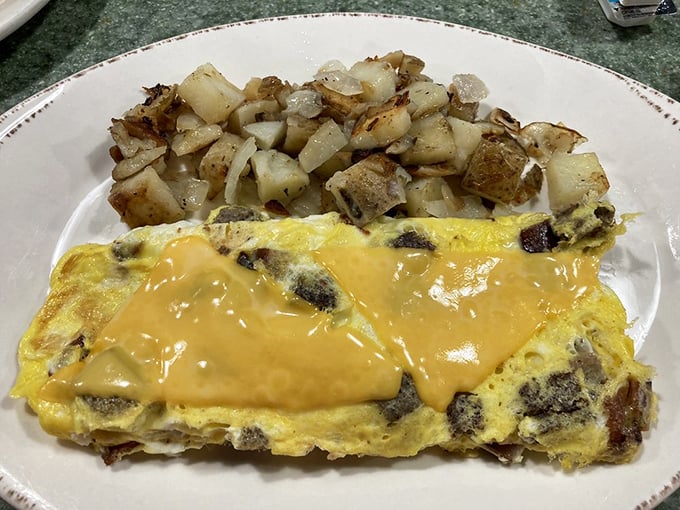 This omelet doesn't just contain cheese &ndash; it celebrates it. Paired with home fries crisped to golden perfection, breakfast doesn't get more honest than this.