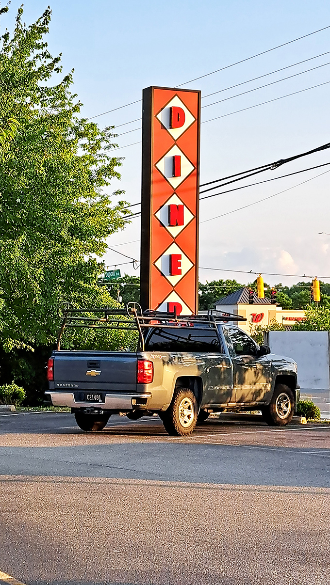 That vertical sign stands like a beacon of hope for hungry travelers. "DINER" &ndash; four simple letters that promise so much.