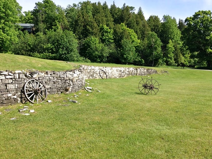 Industrial archaeology never looked so picturesque &ndash; weathered wagon wheels rest against limestone walls, silent witnesses to Fayette's productive past.