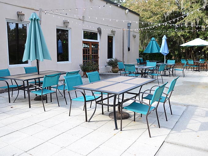 The patio's turquoise chairs invite you to savor your meal under dappled sunlight. Al fresco dining with a side of Savannah charm.
