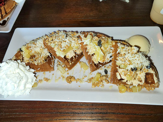 Pineapple-topped waffle triangles line up like tropical soldiers, ready to wage delicious war on your hunger. The whipped cream is their secret weapon.