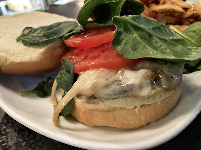 Fresh tomato and melty cheese elevate this sandwich beyond the ordinary. Even the spinach looks excited to be part of this delicious arrangement.