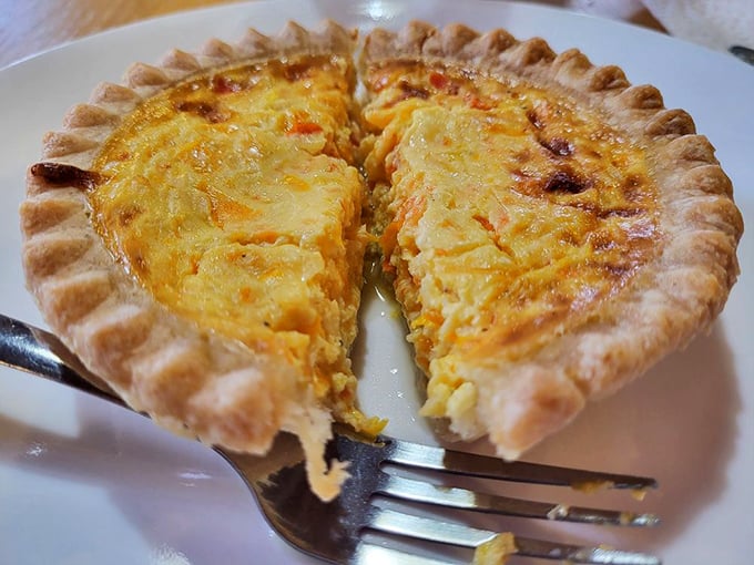 This quiche isn't just baked—it's been coaxed to creamy, savory perfection beneath a crust that shatters with buttery abandon.