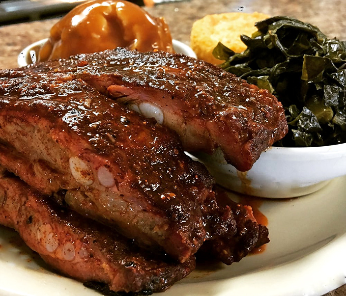Ribs glistening with sauce that required someone's grandmother to perfect over decades. The meat's not falling off the bone—it's voluntarily surrendering.