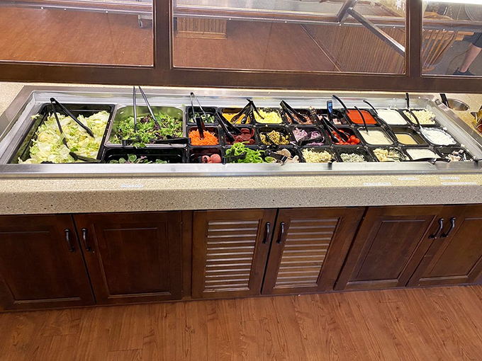 The salad bar—where good intentions meet reality. Fresh ingredients waiting patiently, knowing they'll likely share plate space with much heavier companions from the hot buffet.