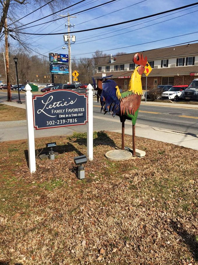 The roadside sign and colorful rooster statue serve as beacons to hungry travelers. Follow the chicken, find happiness.