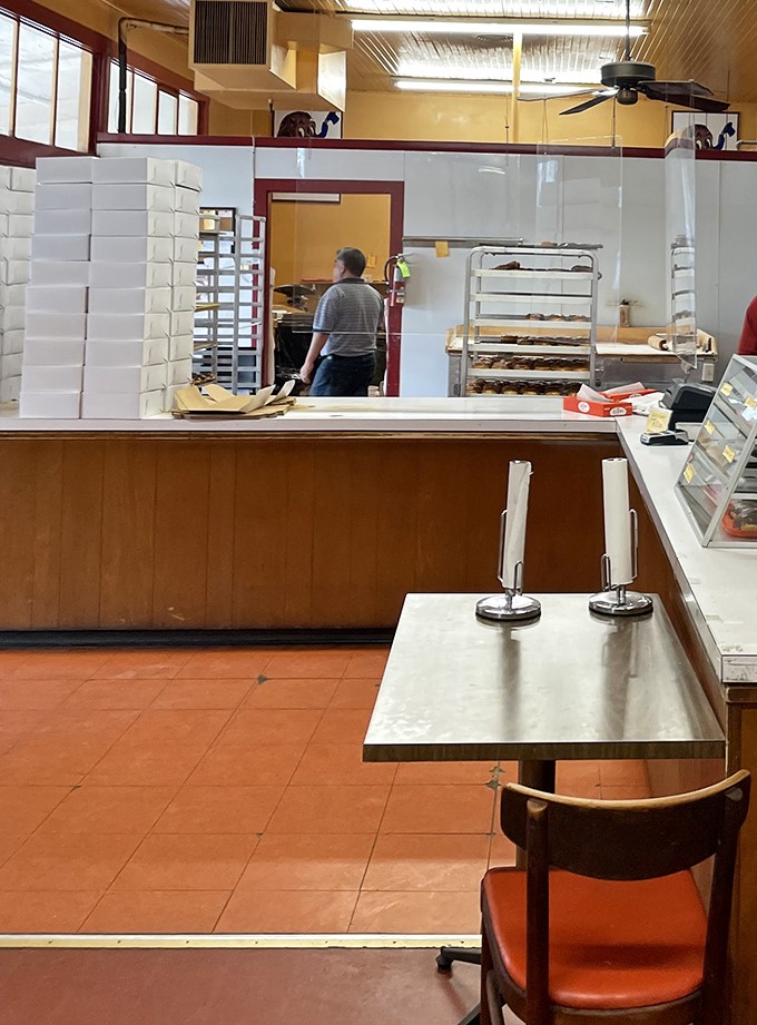 The counter and kitchen maintain that classic mid-century donut shop vibe—functional, unfussy, and focused entirely on the craft.