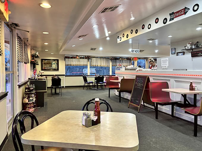 The dining area welcomes you with its unpretentious charm&mdash;red booths, checkered curtains, and the promise of conversations with strangers who might become friends.