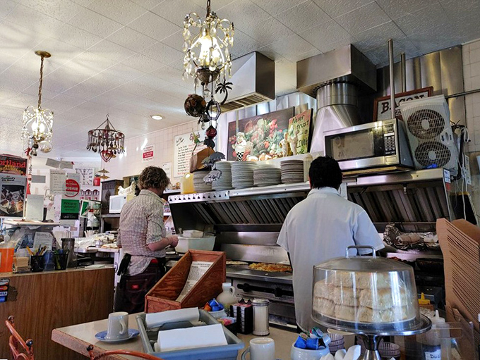 The kitchen ballet: where breakfast dreams materialize under crystal chandeliers and practiced hands that know their way around a griddle. 