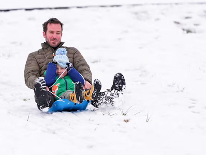 Snow in Georgia might be rare, but this father-son sledding duo knows unexpected joy is always worth bundling up for.