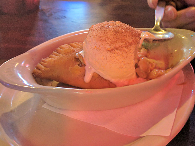 Apple pie gets the Southern treatment: fried, dusted with cinnamon, and crowned with ice cream melting into warm, gooey perfection.