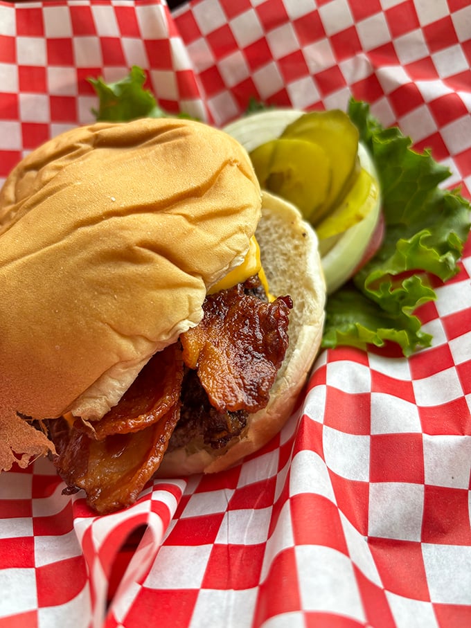 Bacon that's been cooked with respect and reverence, draped over a burger like a savory blanket. This isn't a meal; it's a hug on a bun.