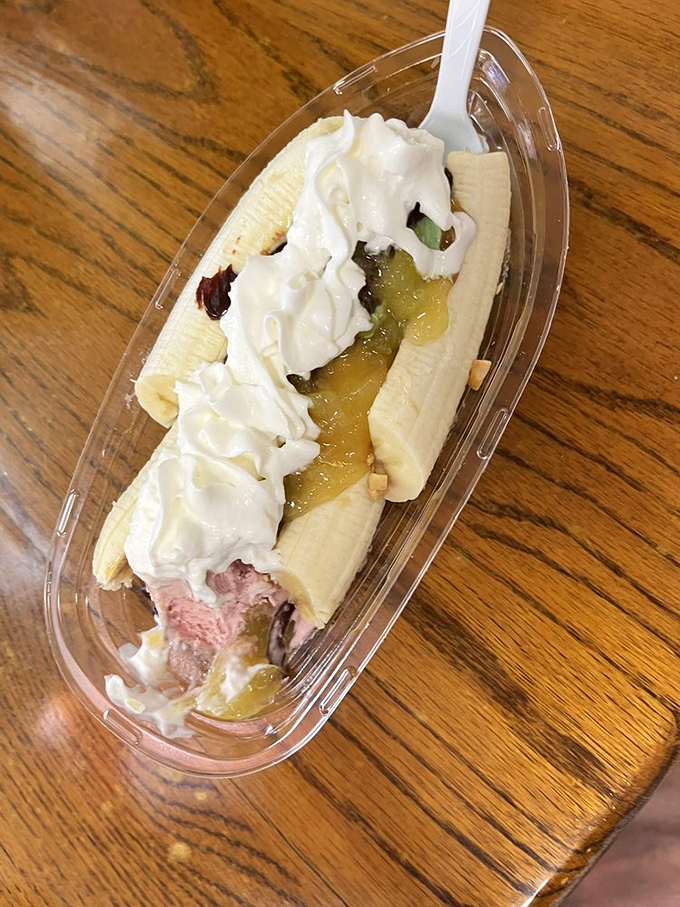 The banana split reimagined&mdash;a boat of nostalgia sailing on a sea of childhood memories, topped with clouds of whipped cream and cherry-red joy.