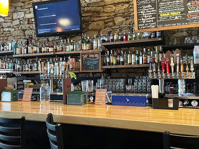 A bar stocked like a liquid library, where craft beers and cocktails wait to be paired with your burger adventure.